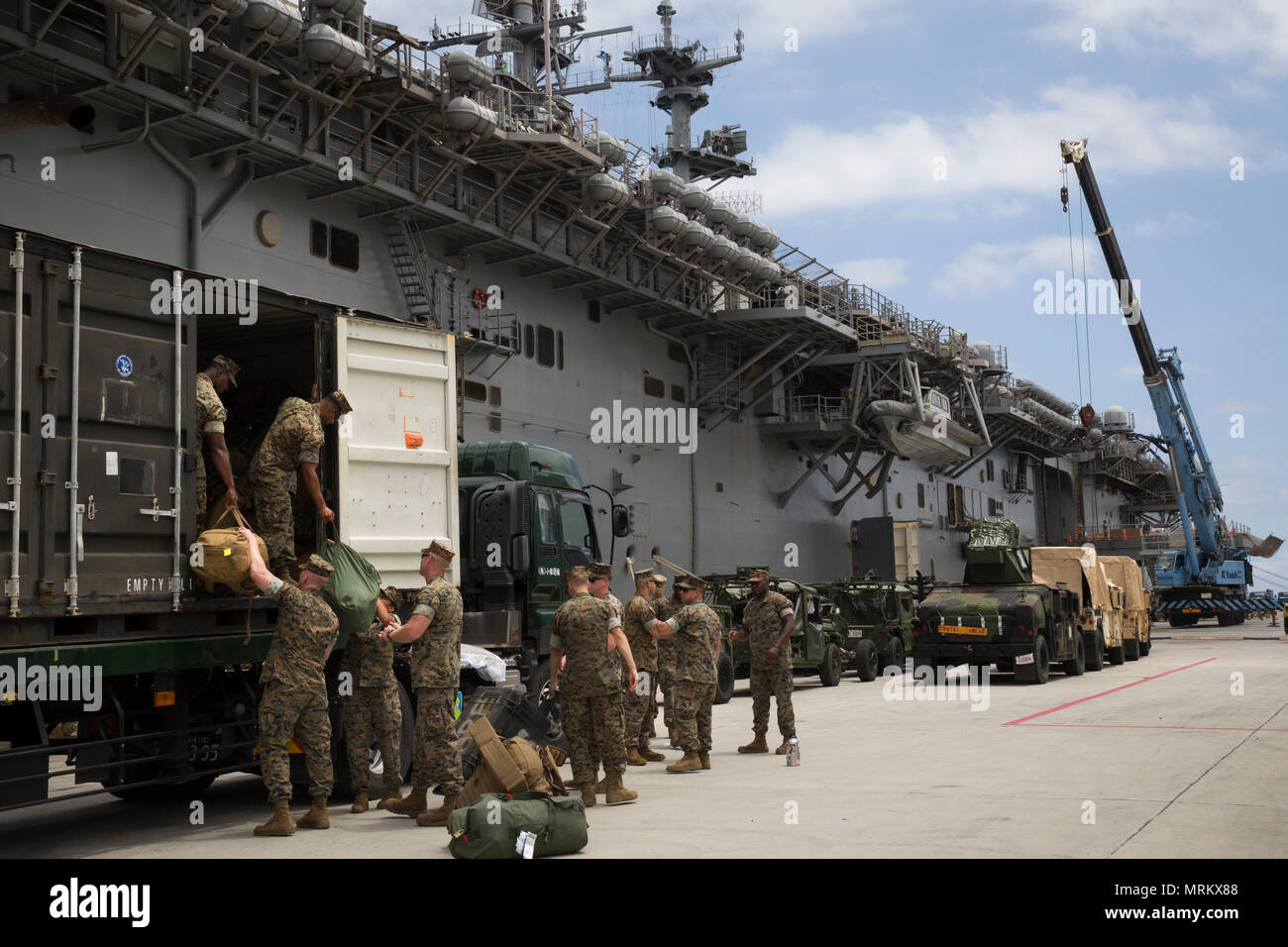 Marines with the 31st Marine Expeditionary Unit unpack a container in ...