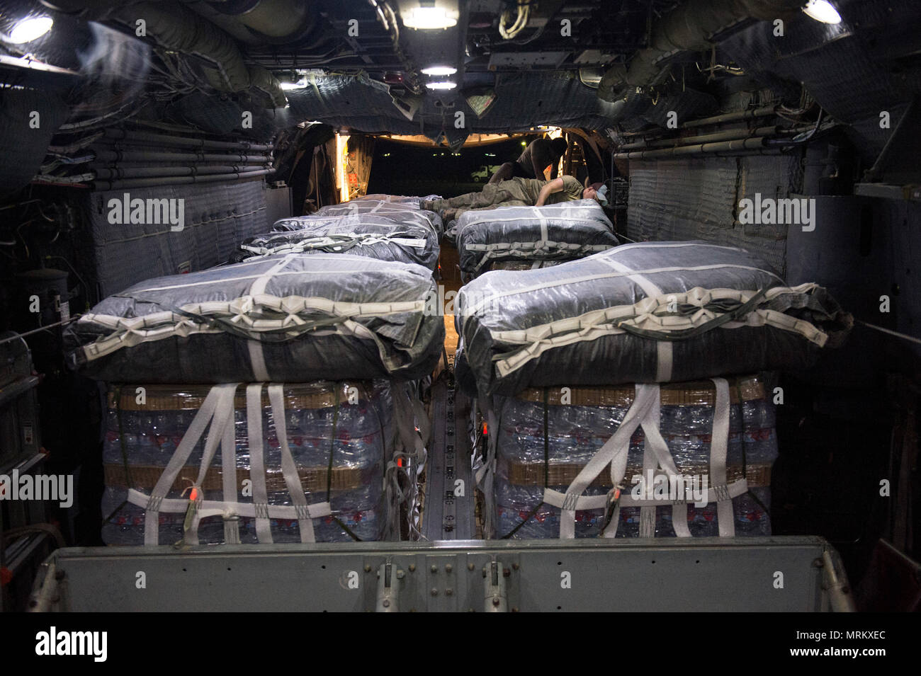 A U.S. Air Force MC-130 crew prepares for a resupply airdrop over an ...