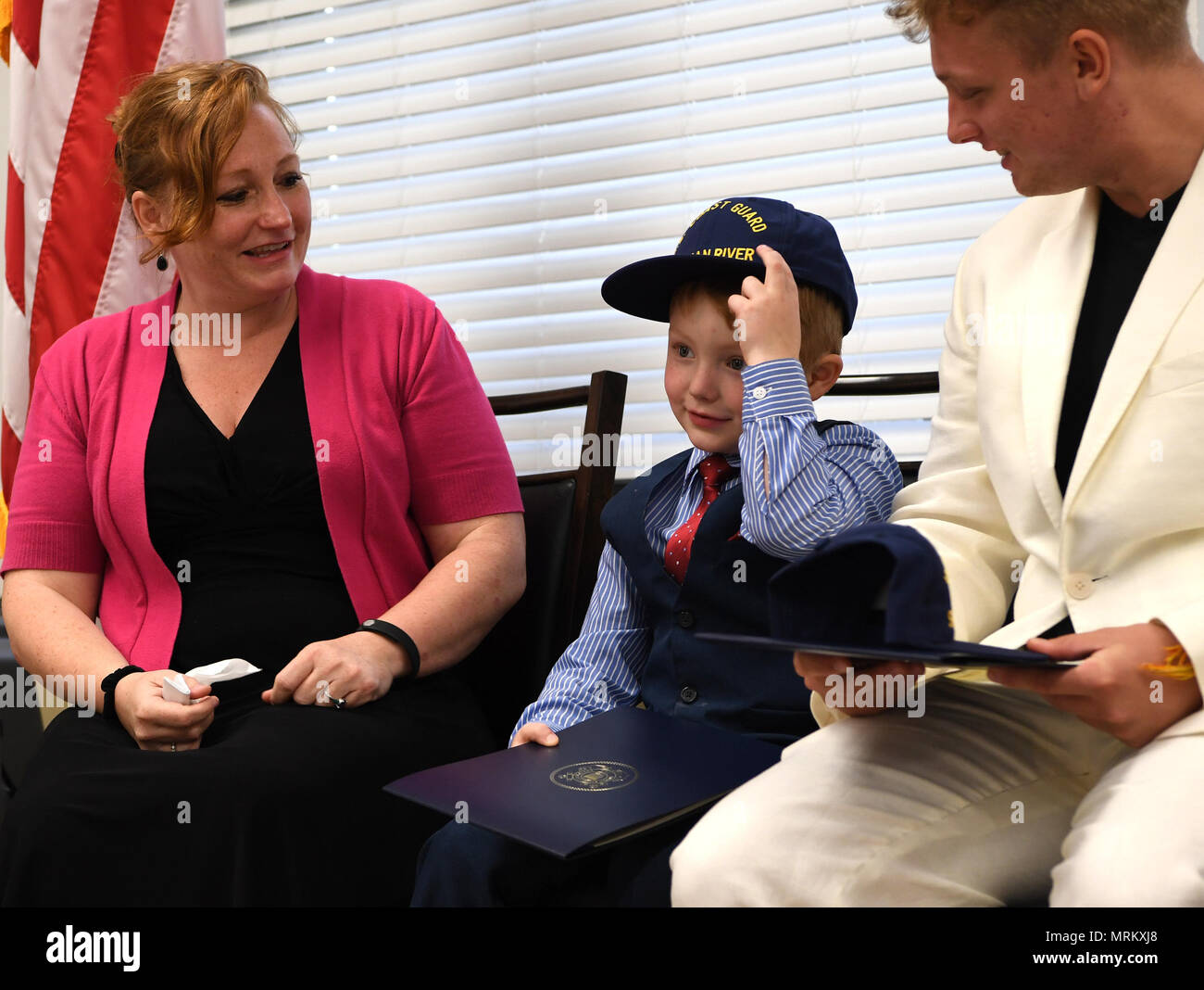 Michael Manley Jr. tries on his Coast Guard cover after being made an ...