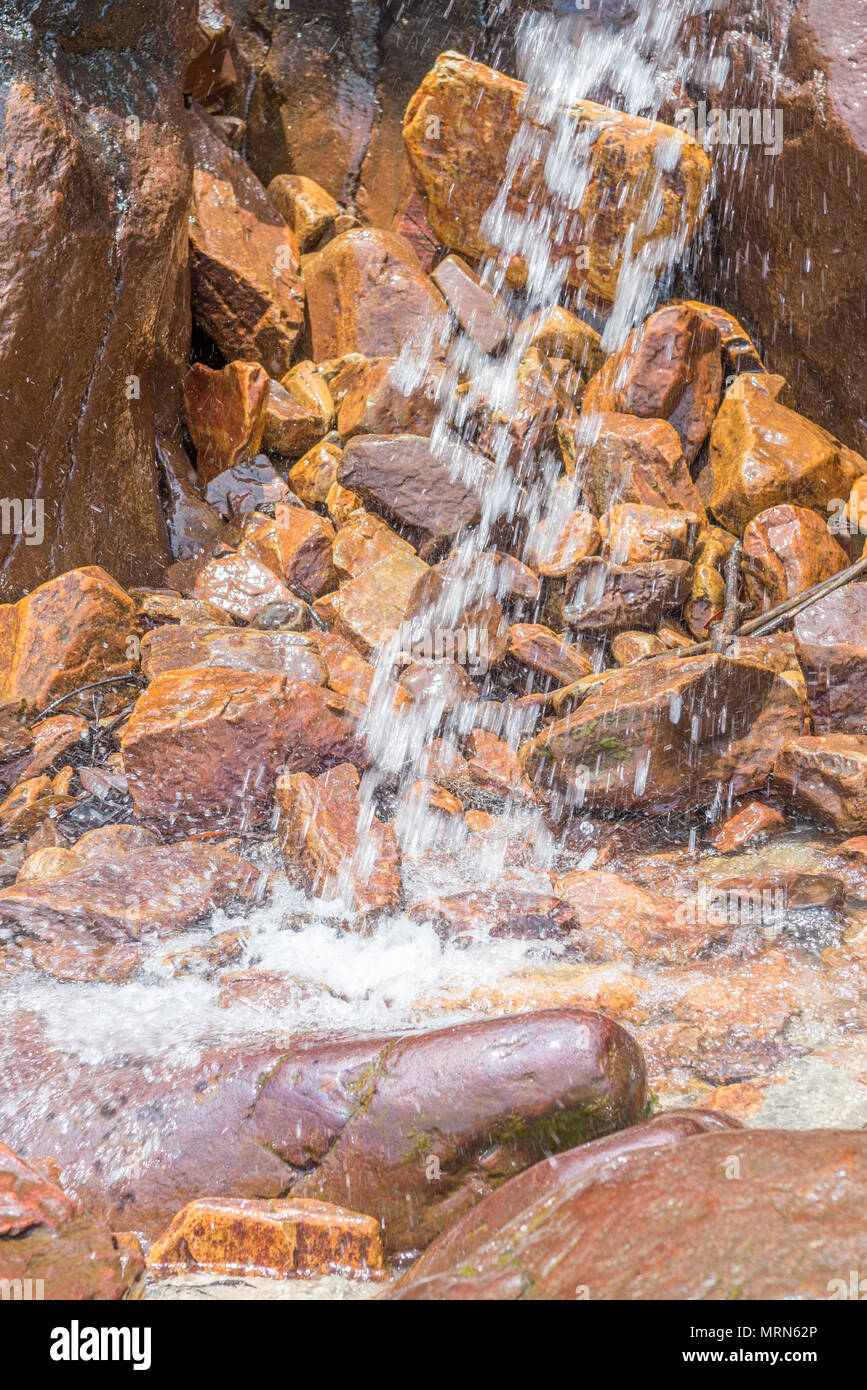 Small waterfall among rocks and stones in moss by the beach Stock Photo ...
