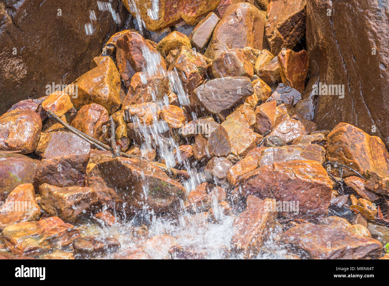 Small waterfall among rocks and stones in moss by the beach Stock Photo ...