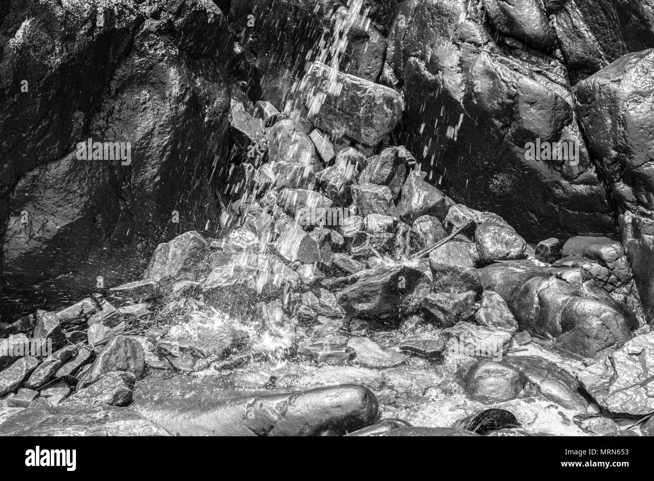 Small waterfall among rocks and stones in moss by the beach Stock Photo ...