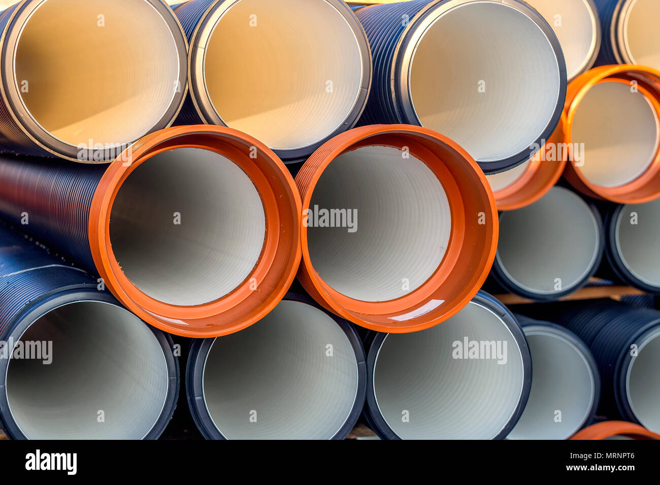 Pile of corrugated PVC sewer or drain pipes background of large ...