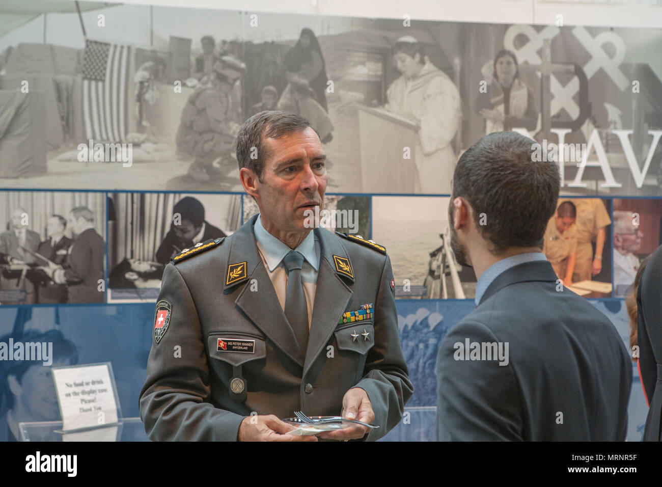 Swiss Maj. Gen. Peter Wanner, naval attaché, speaks with a guest during ...