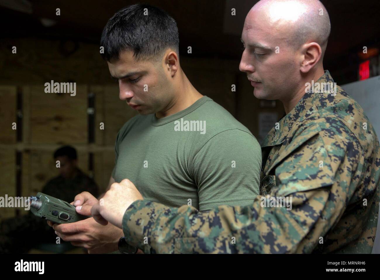 U.S. Marine Lance Cpl. Sean R. Hickford, right, a radio operator with ...