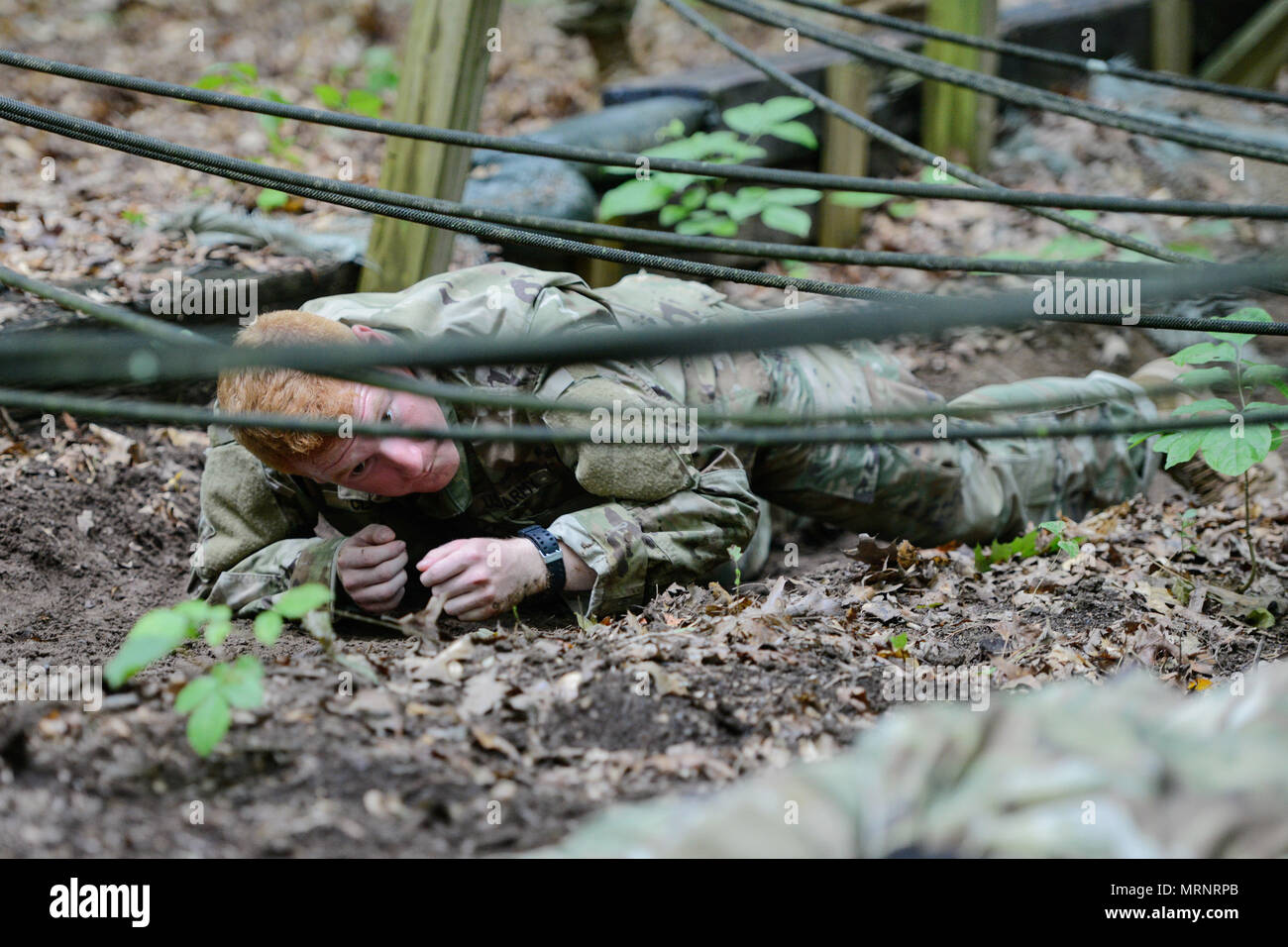 A Soldier scrambles under the ropes on the Grabairz Confidence Course ...