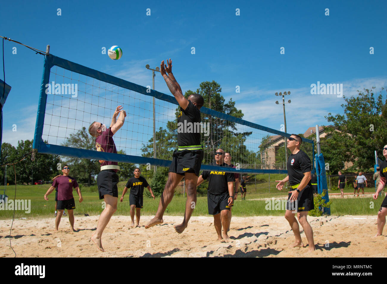 Soldiers from 3rd Expeditionary Sustainment Command, leap into the air ...