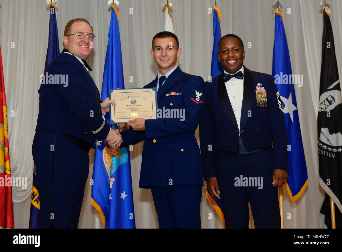 U.S. Coast Guard Petty Officer Third Class Robert Altom receives his ...