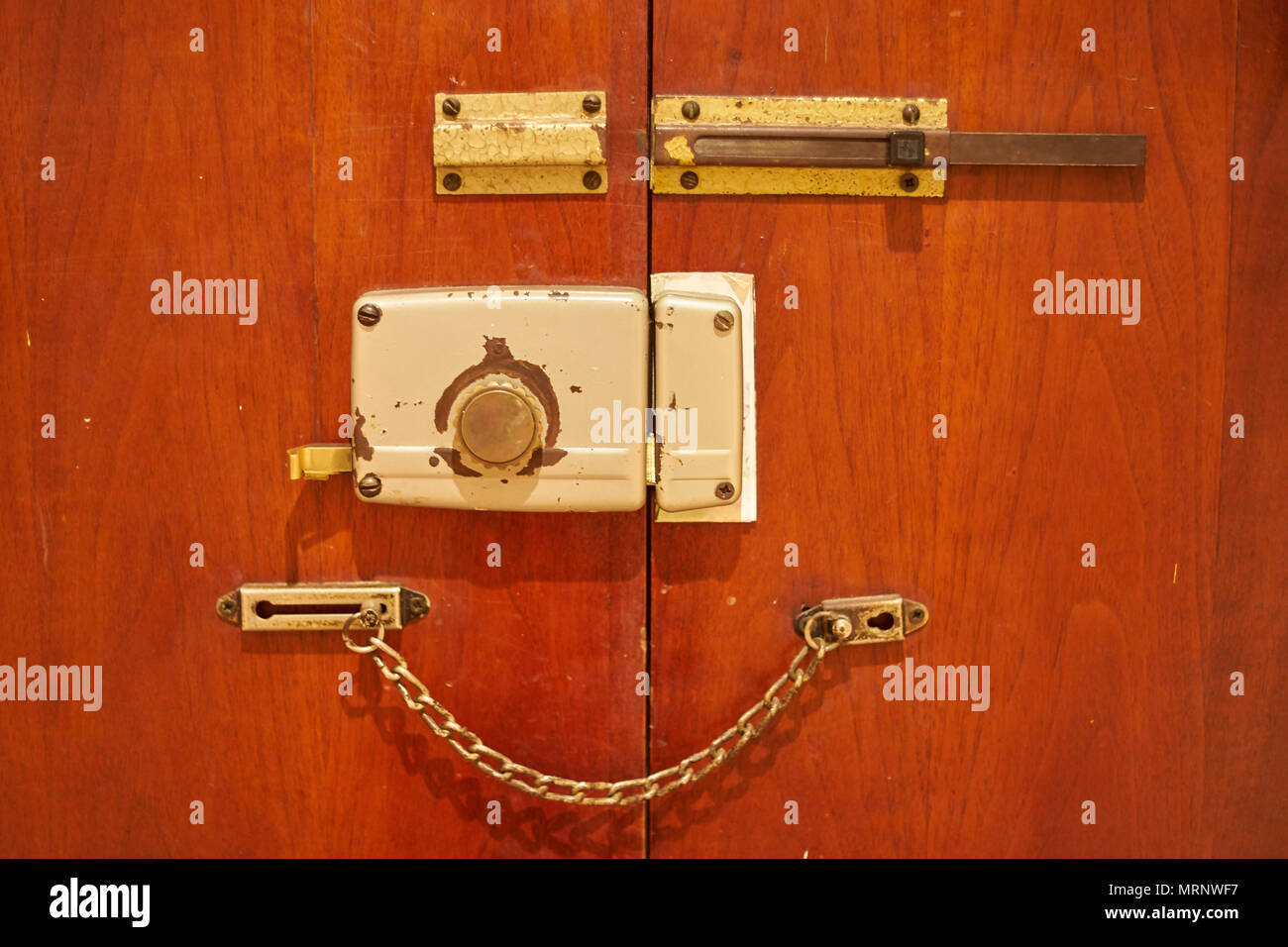 Aged Vintage Door Locks On A Wooden Door With Chain And Security Bar ...