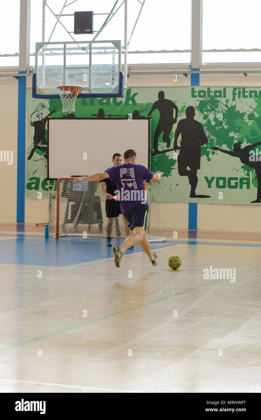 A civilian with 39th Signal Battalion is about to shoot a ball as ...