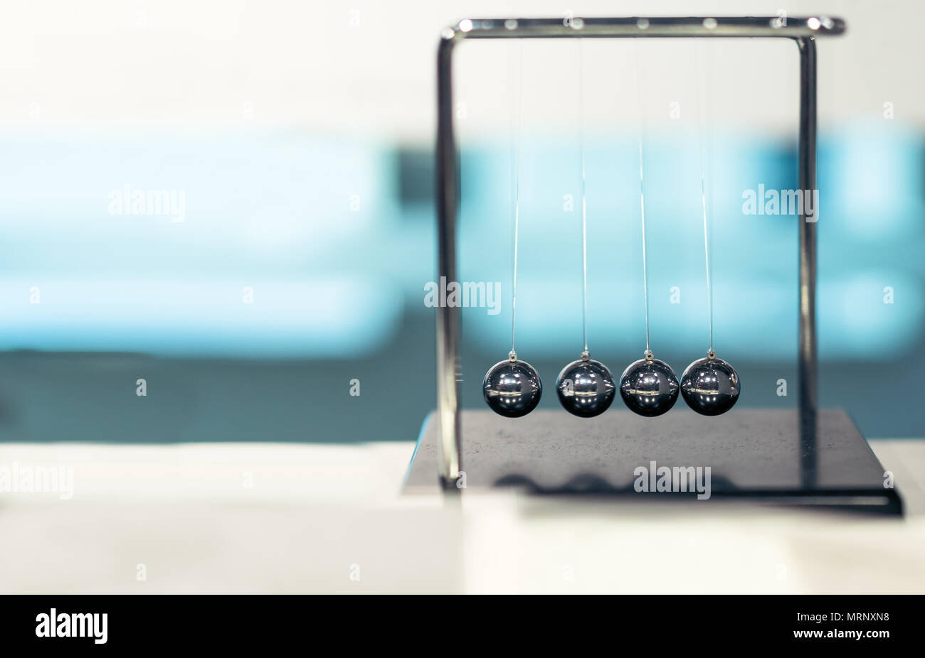 Balancing Balls Newton's Cradle on blurred backgrounds Stock Photo - Alamy