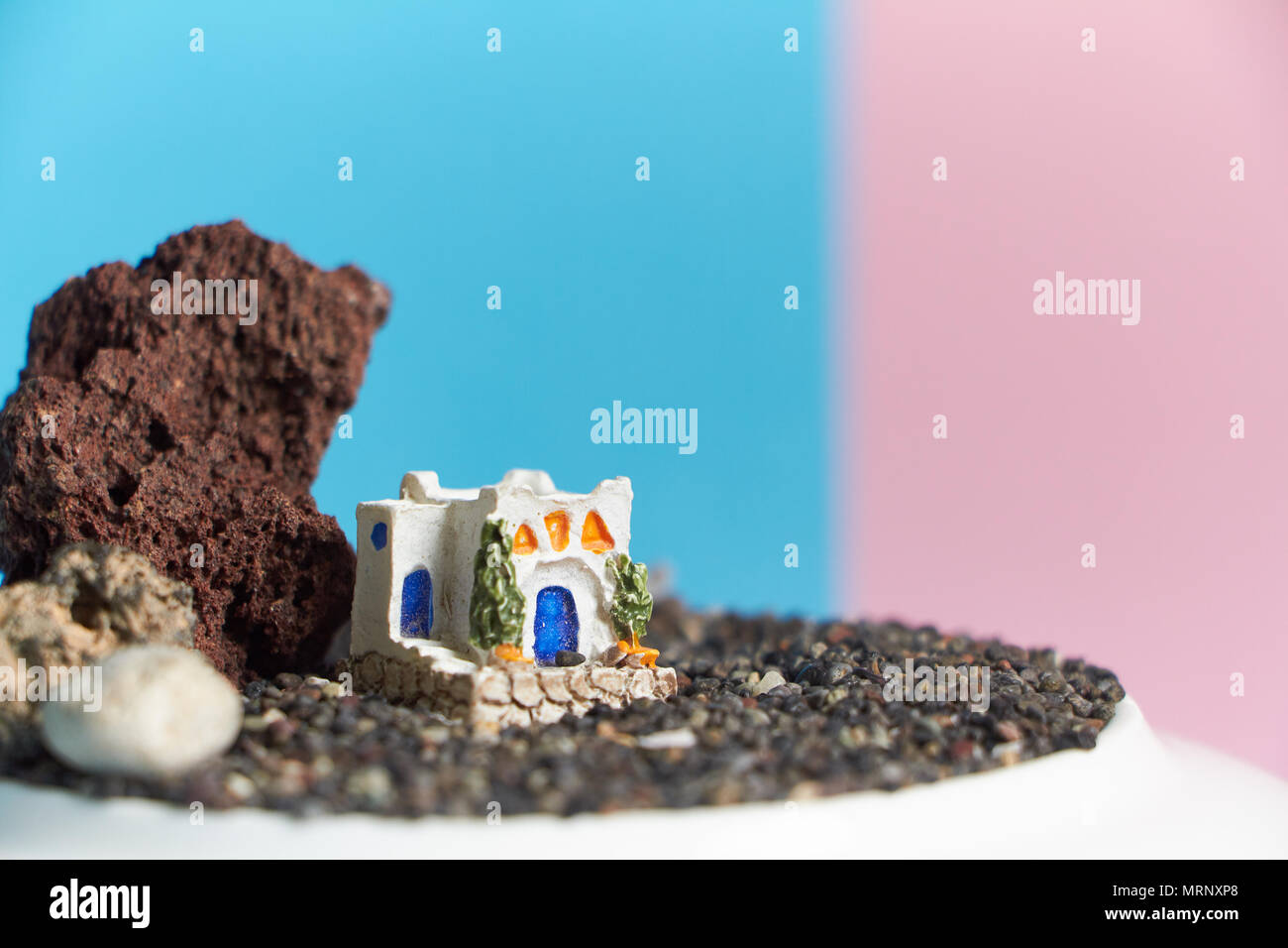 Animated model of a Greek house on a rock on a neon and pink background ...