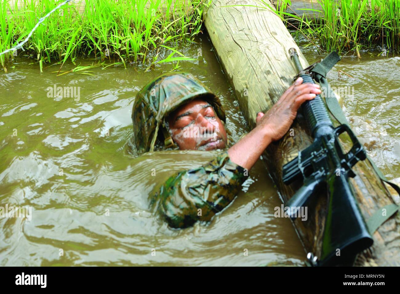 A Marine navigates a log obstacle along "The Quigley" in honor of the ...