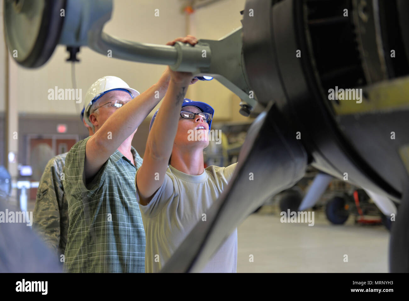 Airman Kellie Bullard, 361st Training Squadron student, installs a ...