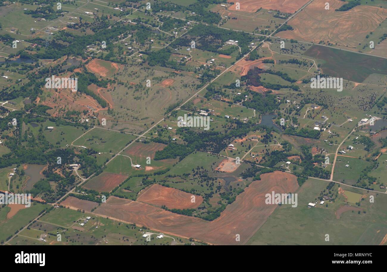 Aerial view of farms, lakes and roads seen from an airplane window ...