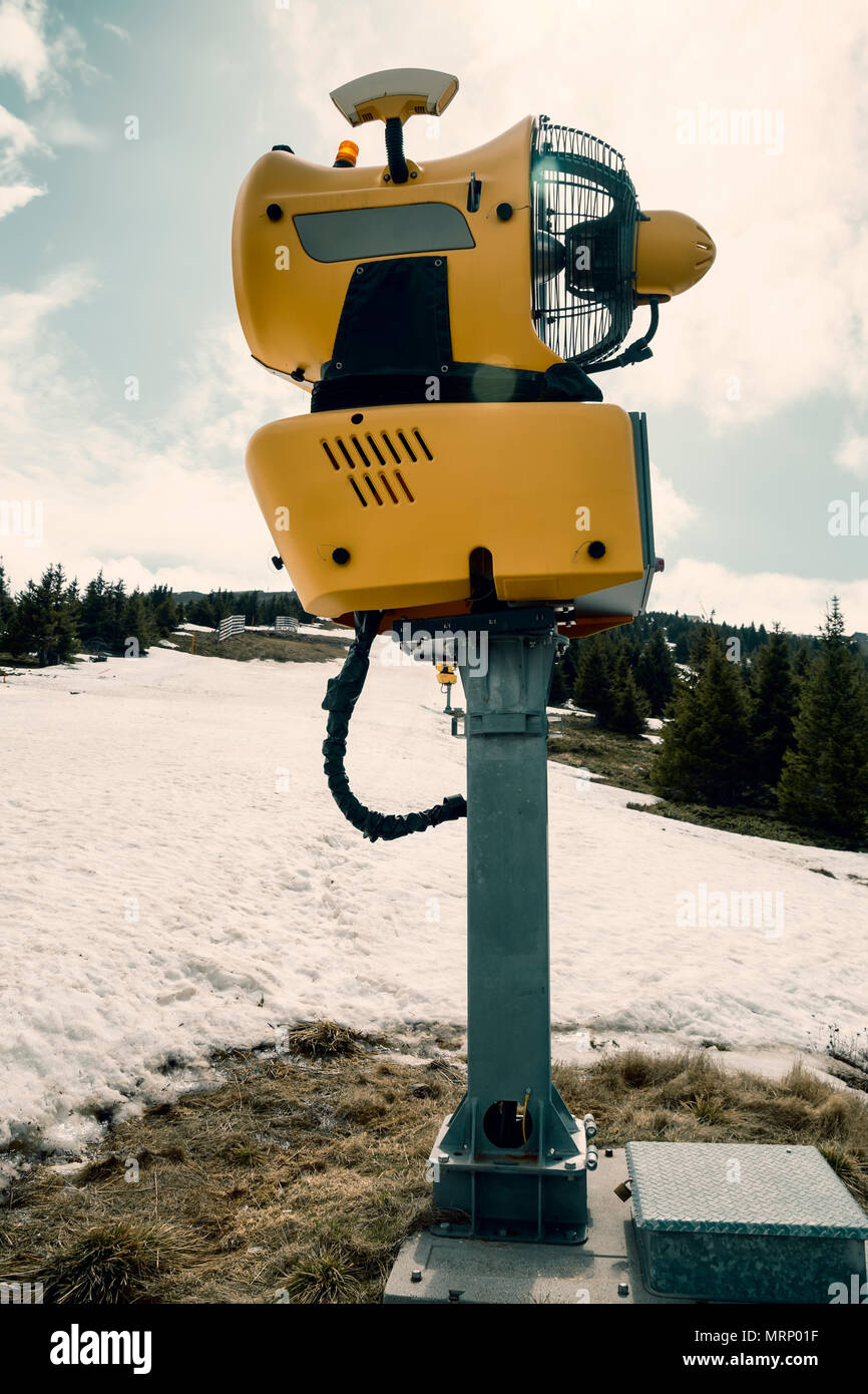 Snow gun machine waiting for frost with sun flare background, snowmaker ...