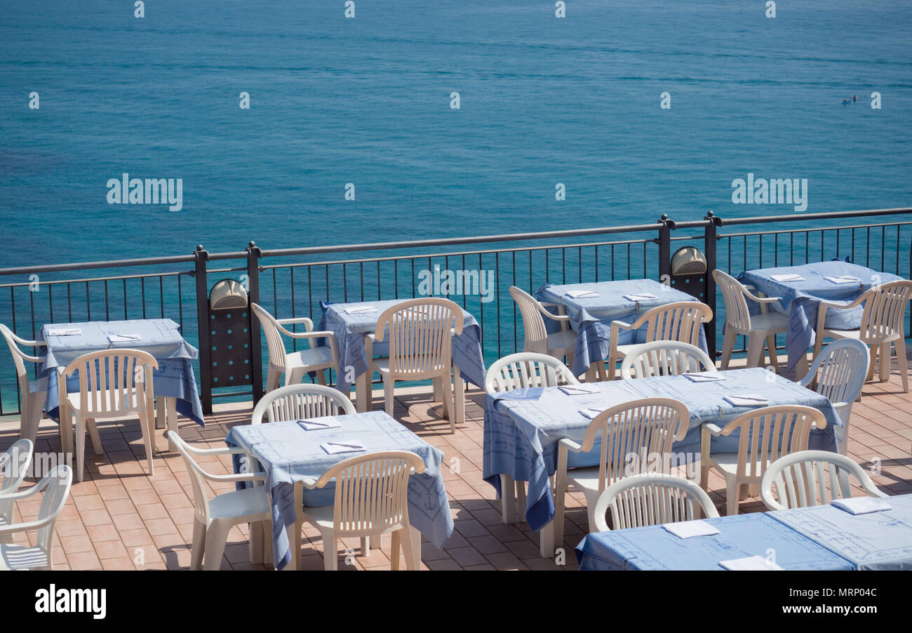 Restaurant tables overlooking mediterranean sea hi-res stock ...