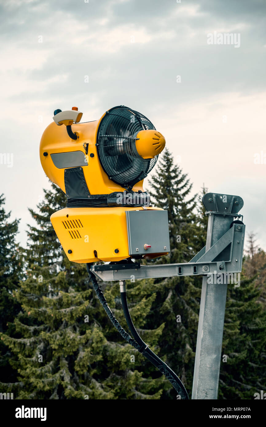 Snow machine waiting for frost with sky background, snowmaker machine ...