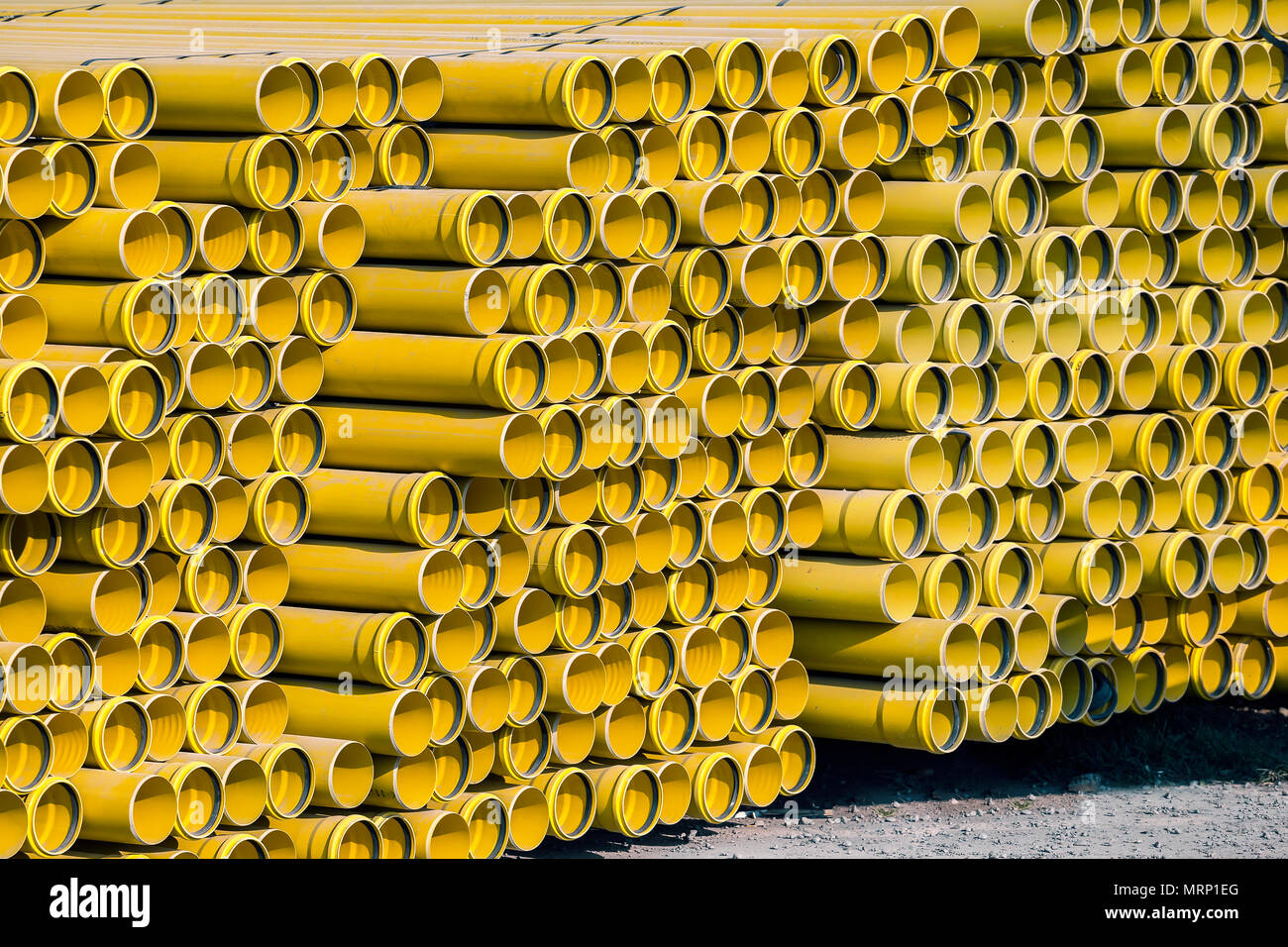 Stack of pvc pipes background at construction site. Selective focus and ...