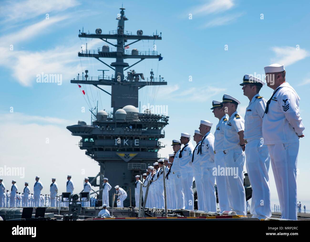 Sailors man the rails on the flight deck aboard the aircraft carrier ...