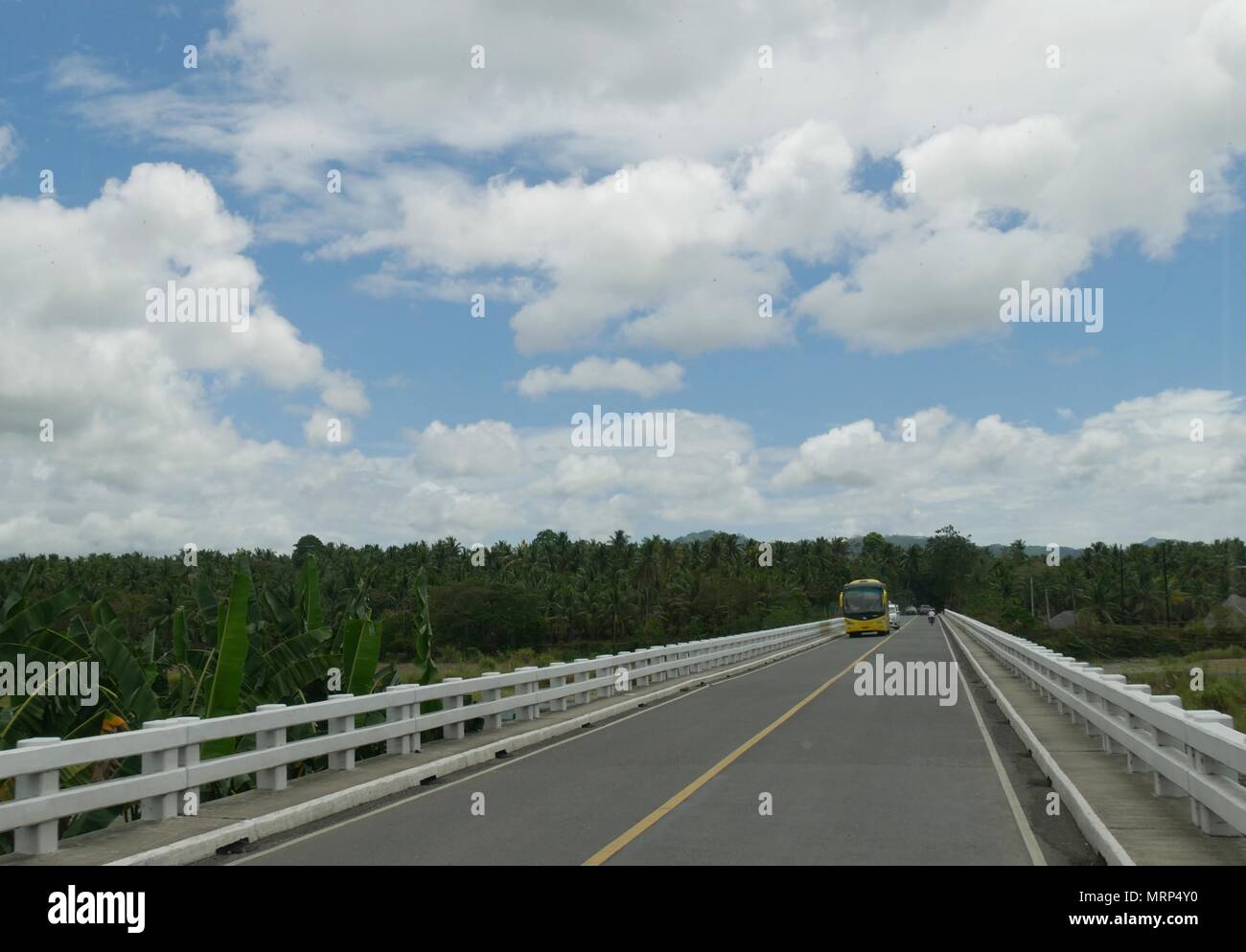 Tagum, Davao del Norte, March 2016: Vehicles travel through a long ...