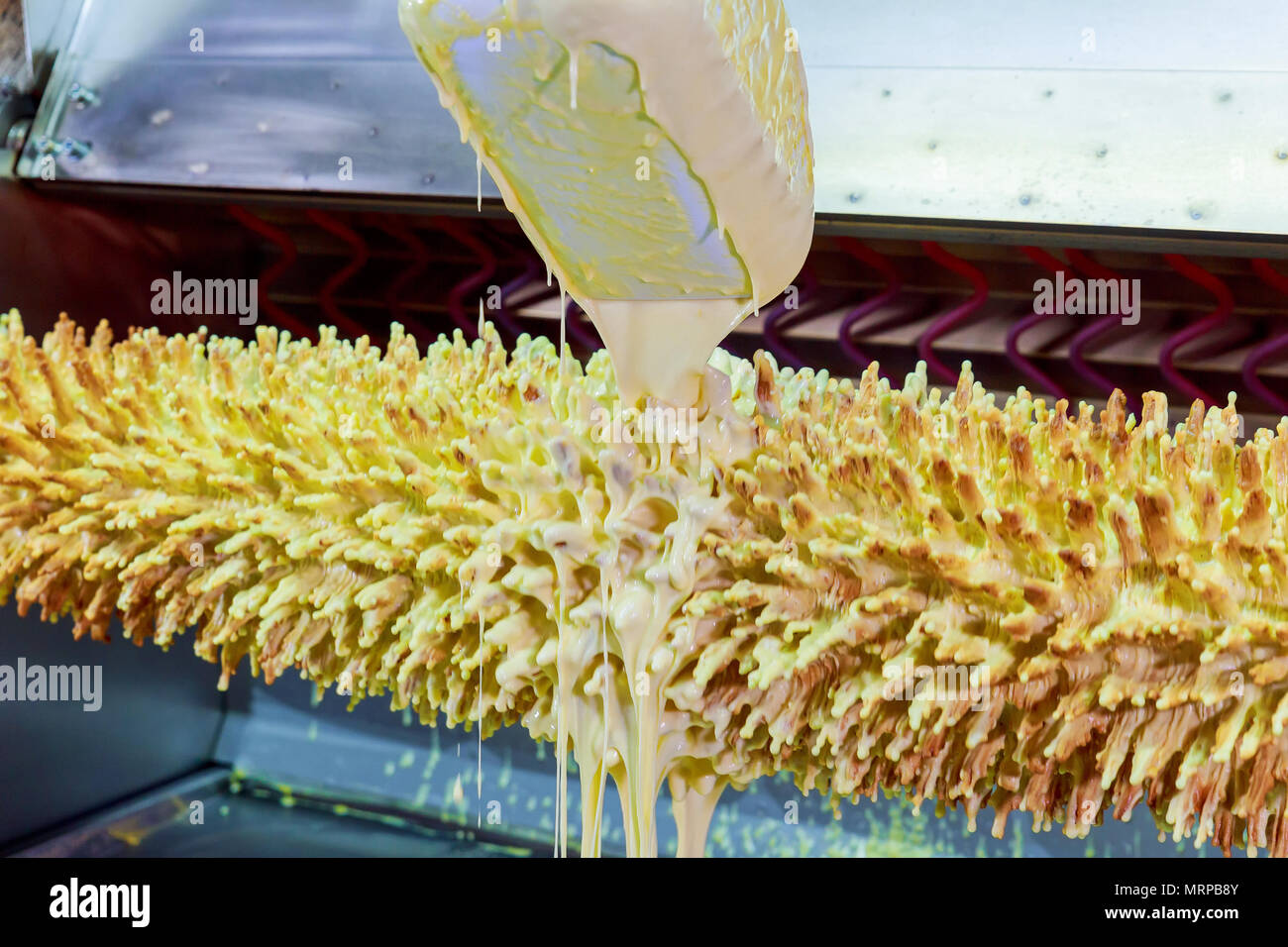 Cooking Traditional Lithuanian cake on skewer, selective focus in ...