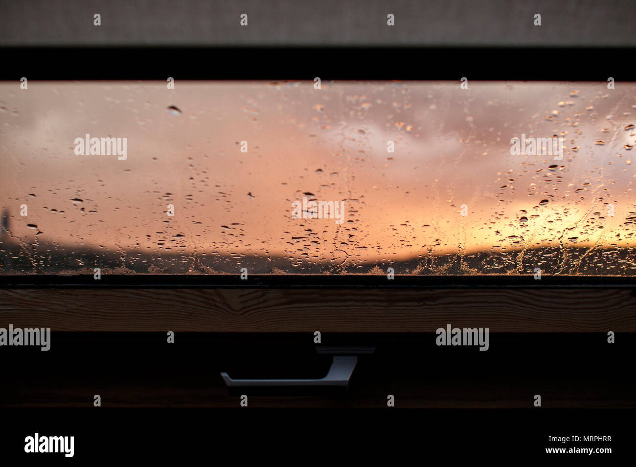 sunset on rainy day through window Stock Photo - Alamy