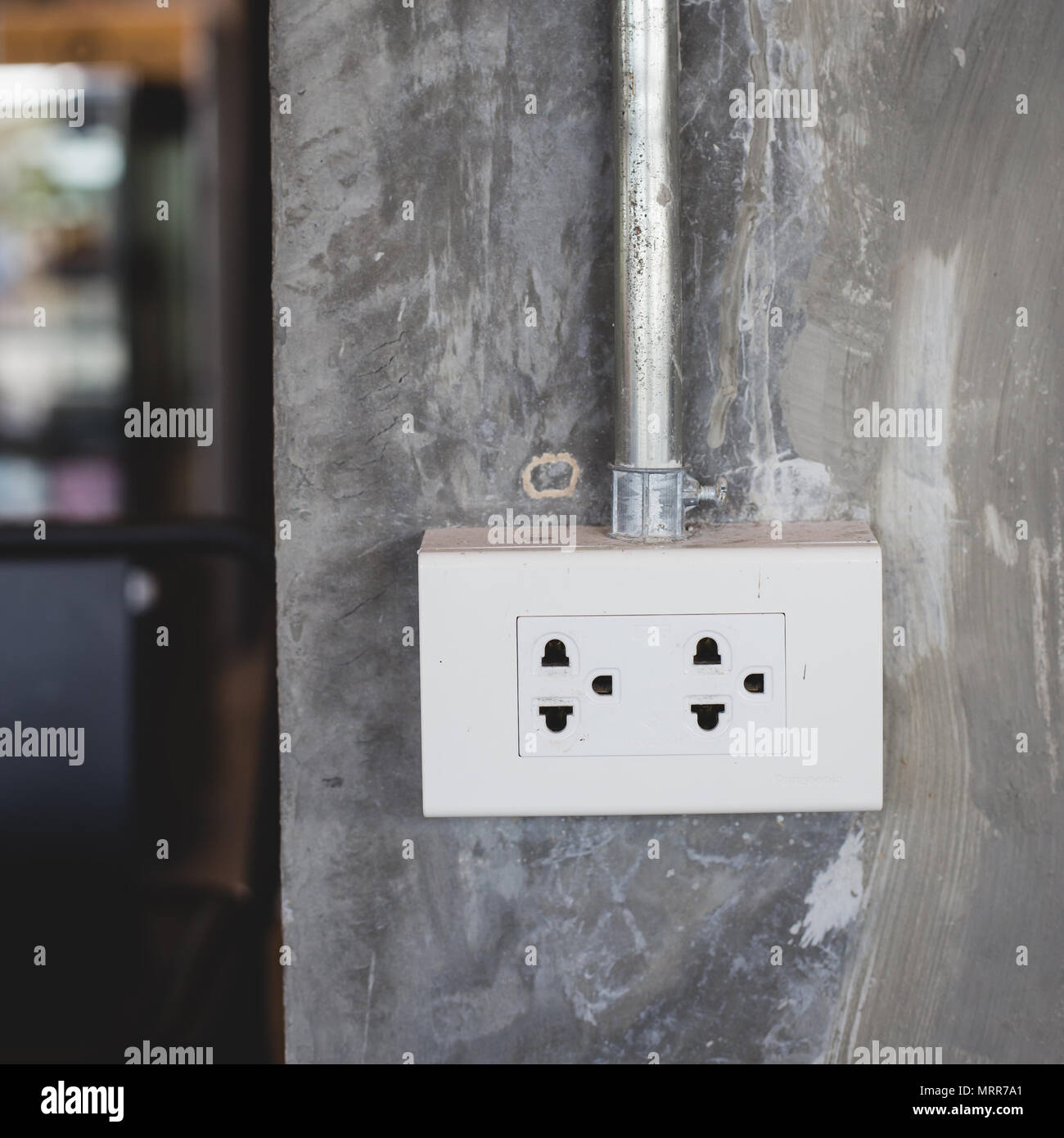 Power socket on stone pillar in cafe , service device for customer in ...