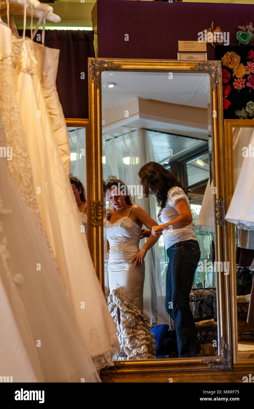 Wedding dress fitting. A bride tries on her dress for the first time ...