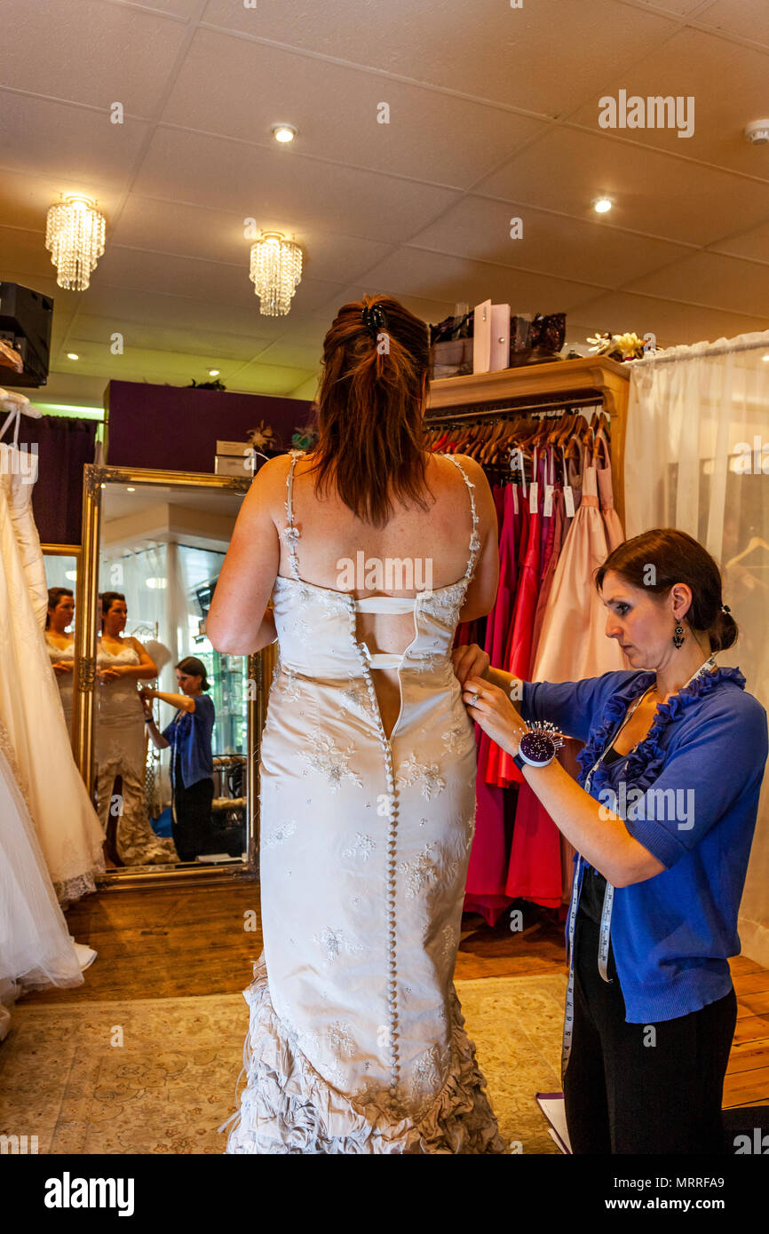Wedding dress fitting. A bride tries on her dress for the first time ...