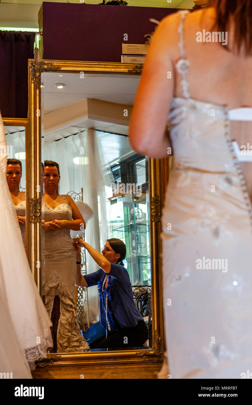 Wedding dress fitting. A bride tries on her dress for the first time ...