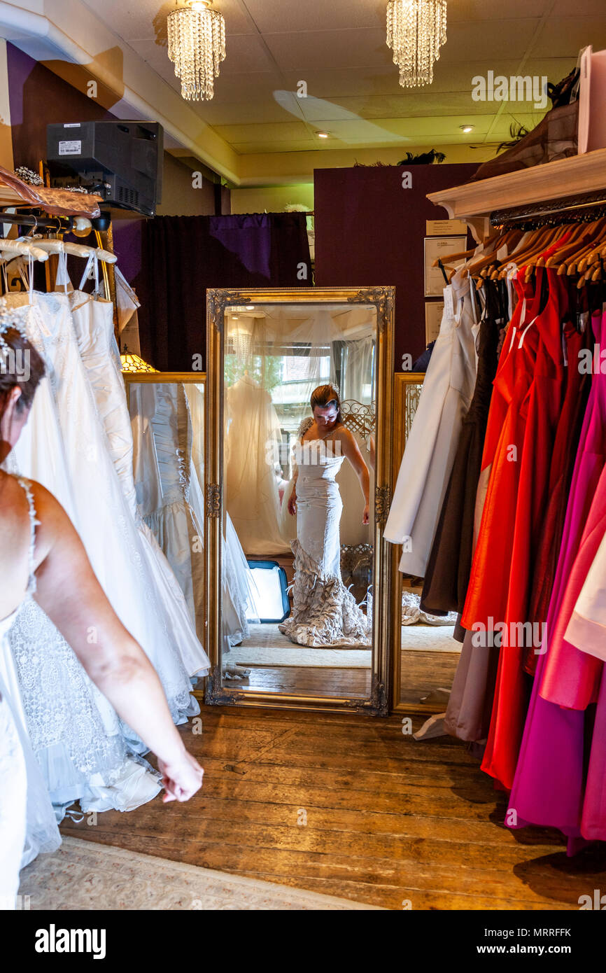 Wedding dress fitting. A bride tries on her dress for the first time ...