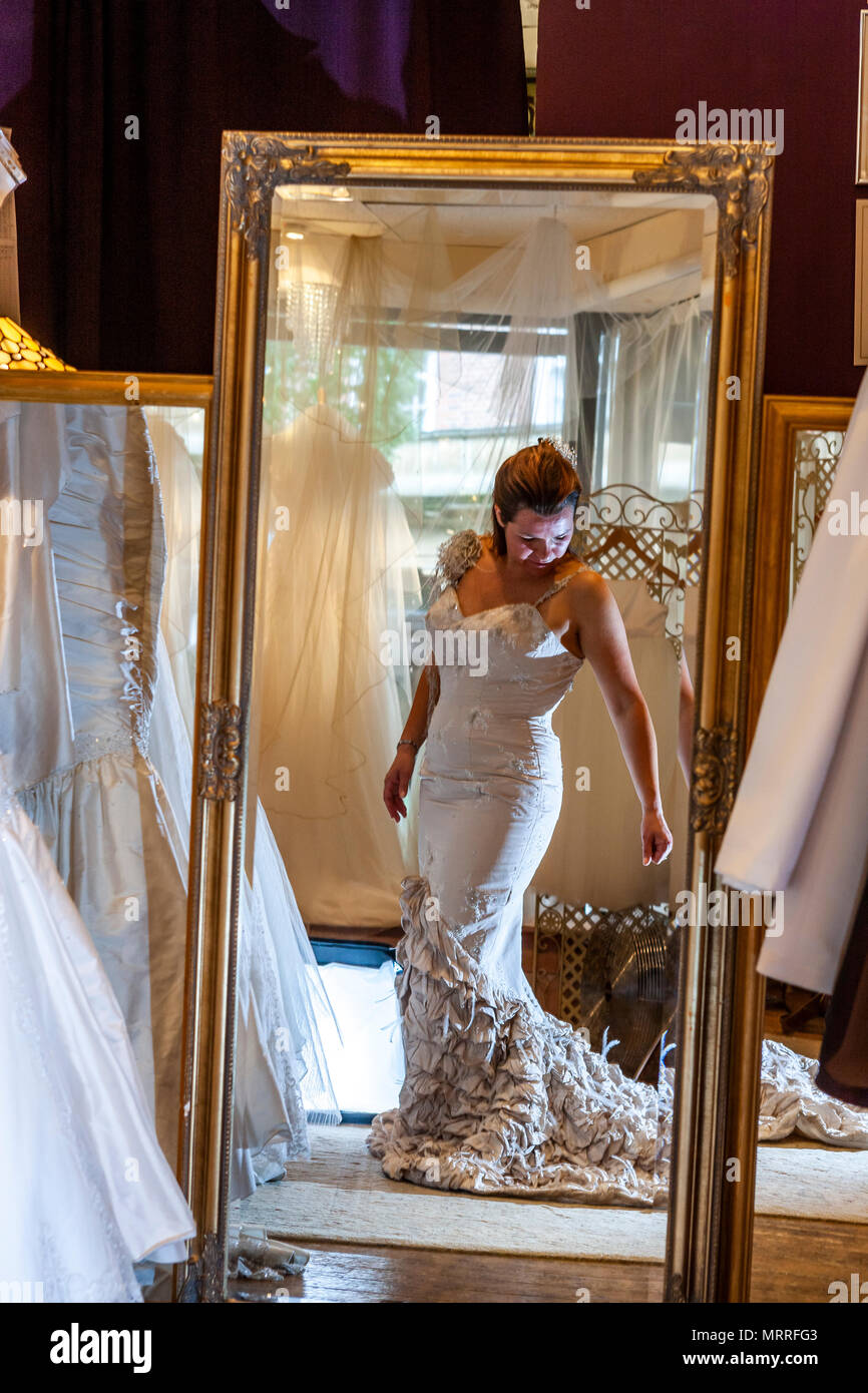 Wedding dress fitting. A bride tries on her dress for the first time ...