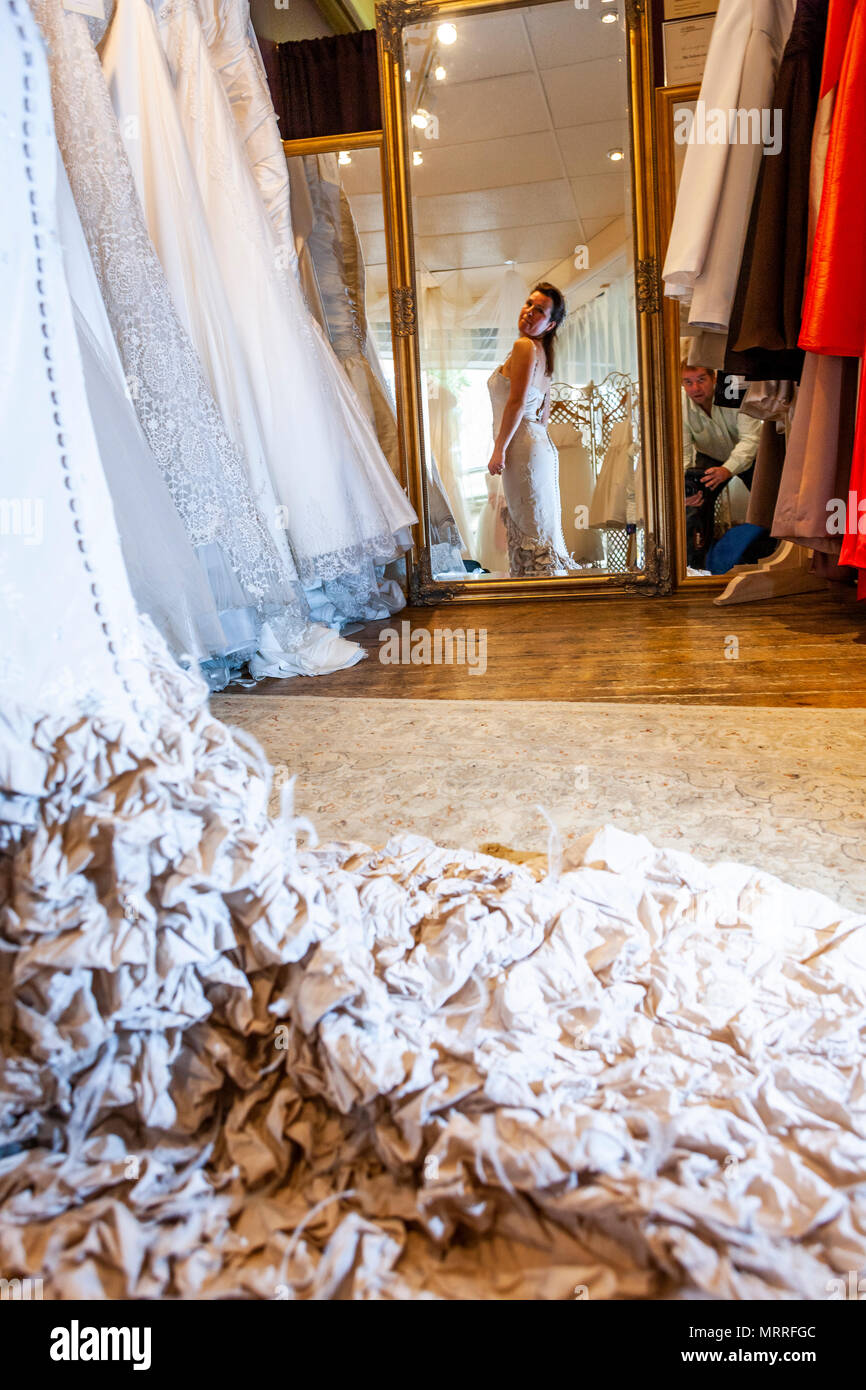 Wedding dress fitting. A bride tries on her dress for the first time ...