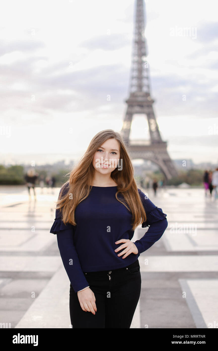Beautiful girl standing in Eiffel Tower background in Paris Stock Photo ... Beautiful girl standing in Eiffel Tower background in Paris Stock Photo ...