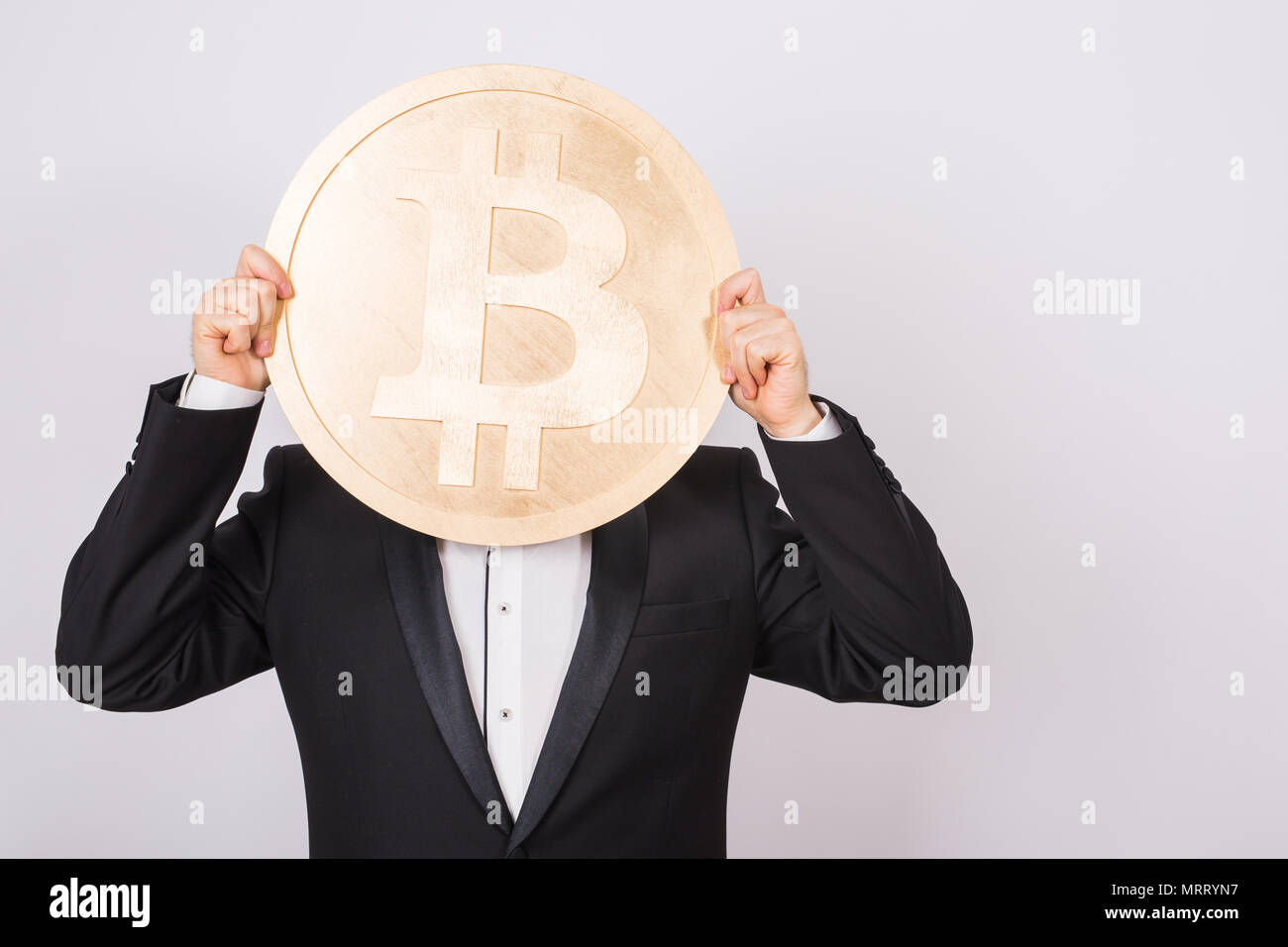Man holding bitcoin on white background Stock Photo - Alamy