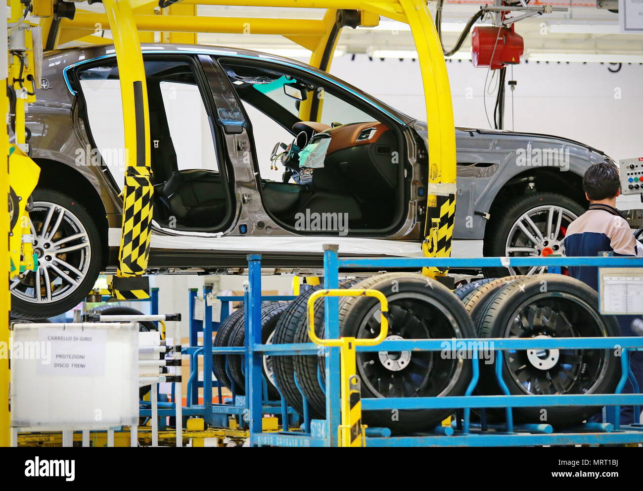 Car production line with unfinished cars in a row at Maserati factory ...