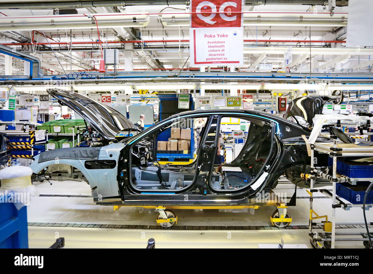 Car production line with unfinished cars in a row at Maserati factory ...