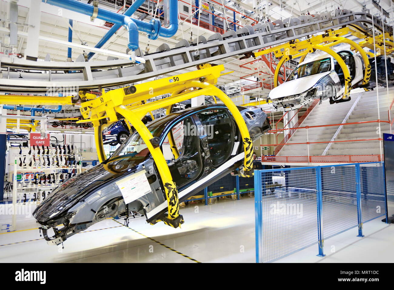 Car production line with unfinished cars in a row at Maserati factory ...