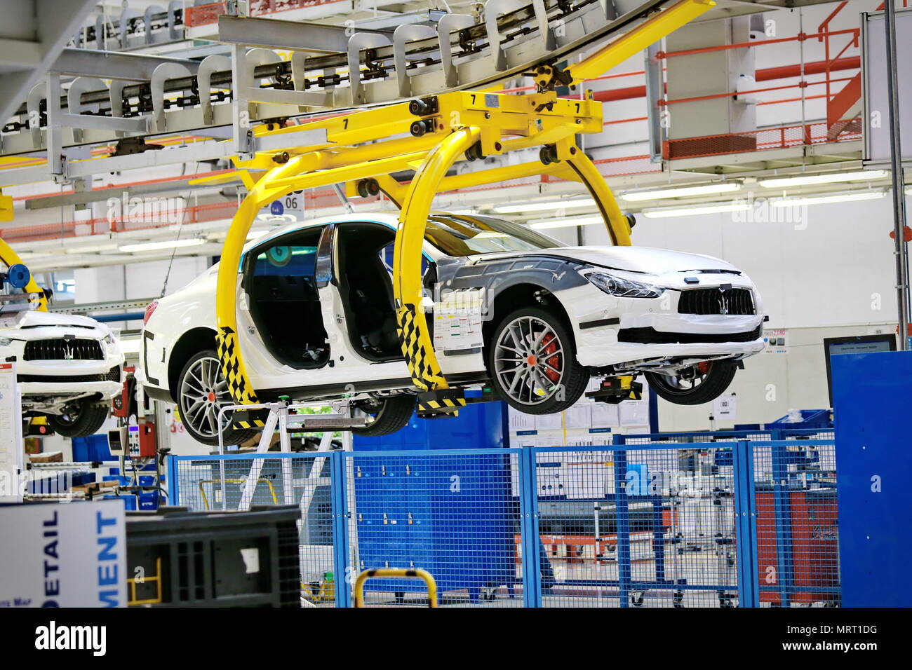 Car production line with unfinished cars in a row at Maserati factory ...