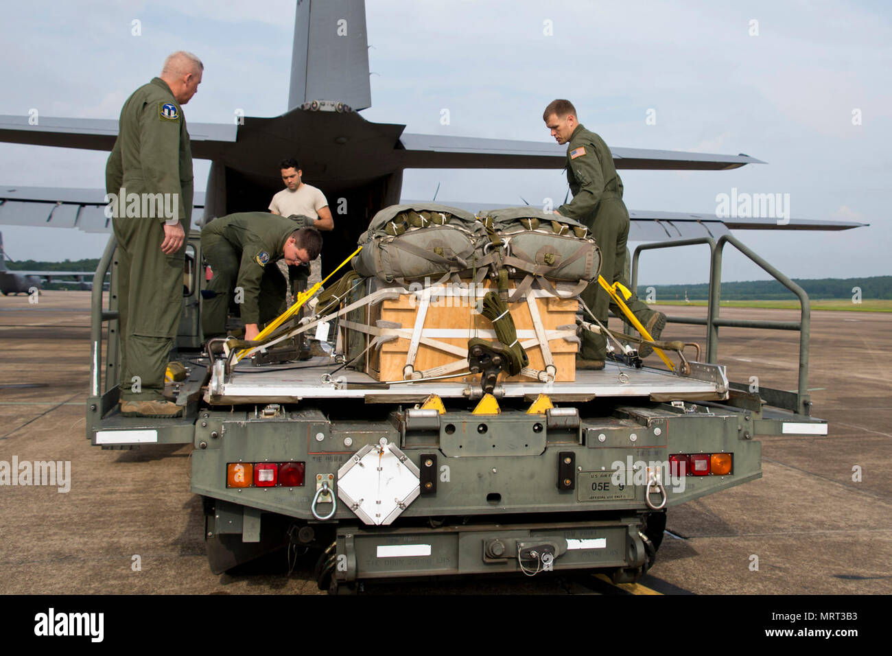 Loadmasters from the 327th Airlift Squadron check a heavy equipment ...