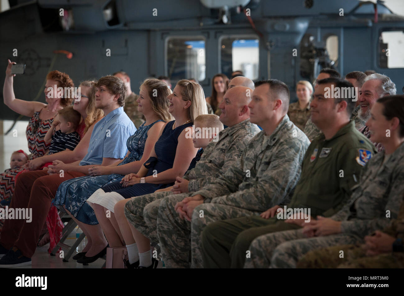 Family and friends watch and laugh during a promotion ceremony, June 28 ...