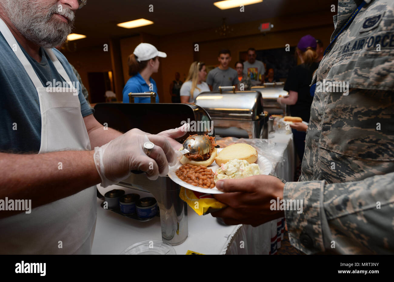 An Airman serves food in the Dakota’s Club during the annual base ...