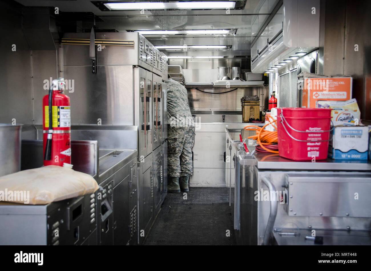 An Airman prepares breakfast inside of the Disaster Relief Mobile ...
