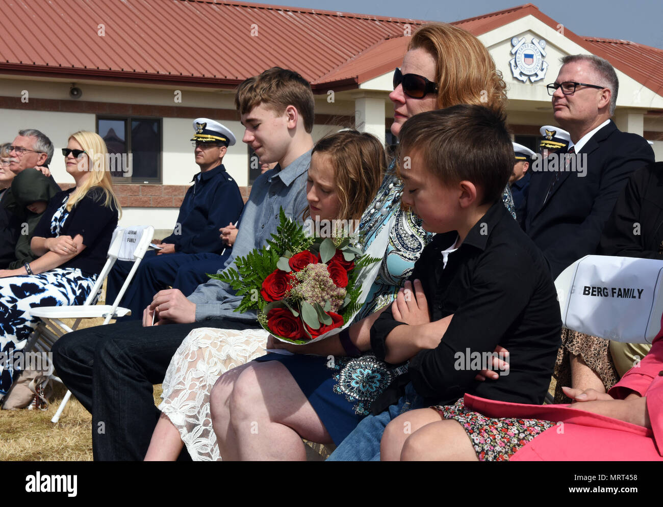 Family members of Cmdr. Benjamin D. Berg listen as Berg delivers a ...