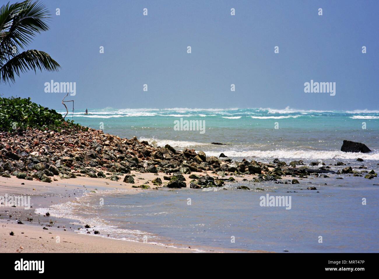 Rocks on the white sand Micro Beach in Garapan, Saipan adds attraction ...
