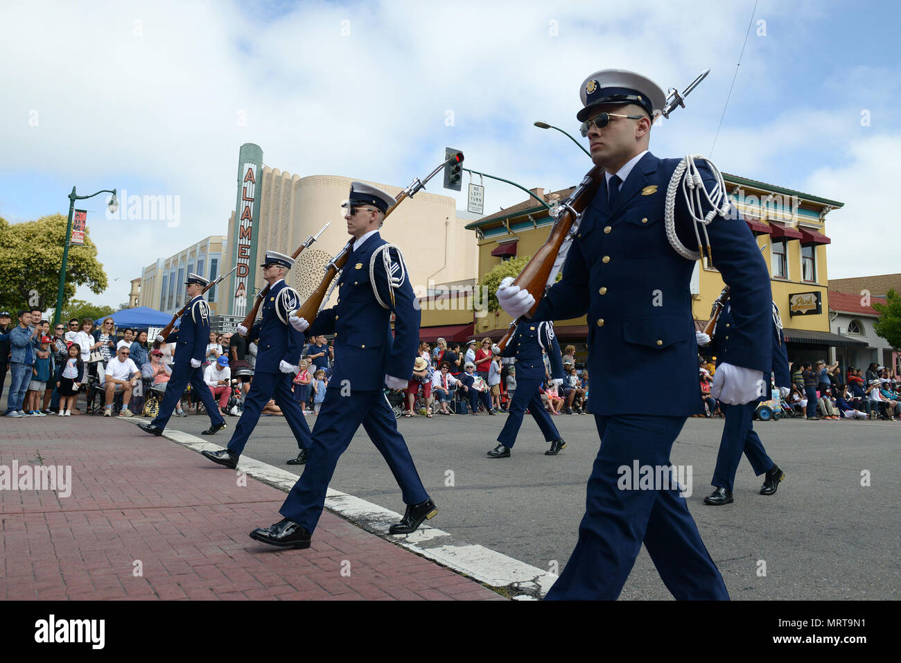 Members of the Coast Guard Ceremonial Honor Guard march in a fourth of ...