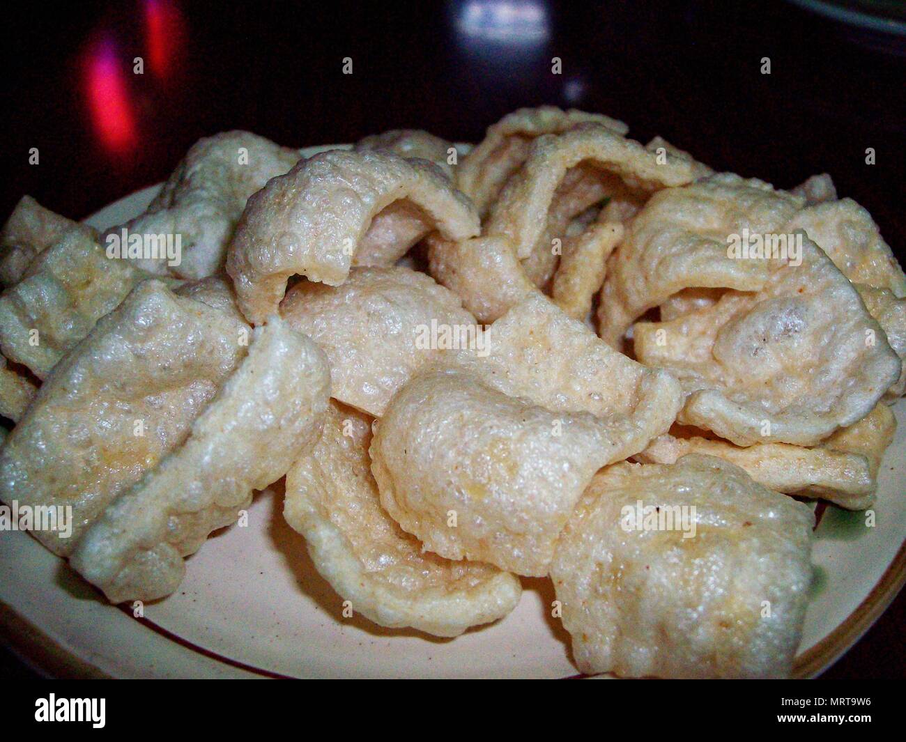 Deep-fried ruffled fat from pork belly or pork rinds, or other meat ...