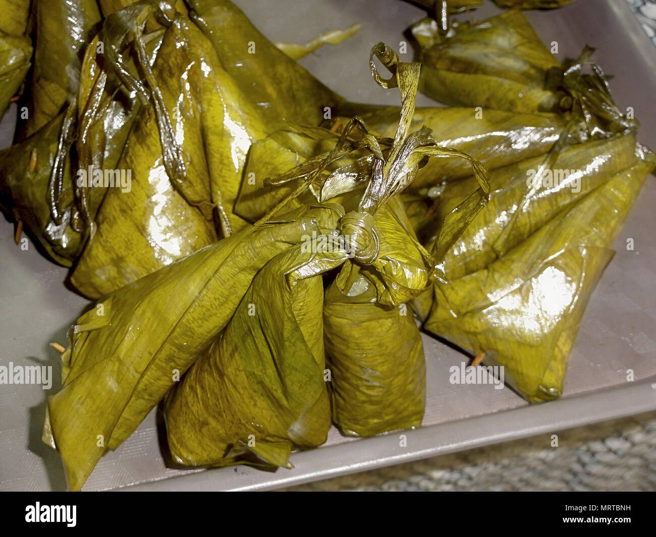 wrapped Puto Maya in a metal tray Inside these oily banana leaves are ...
