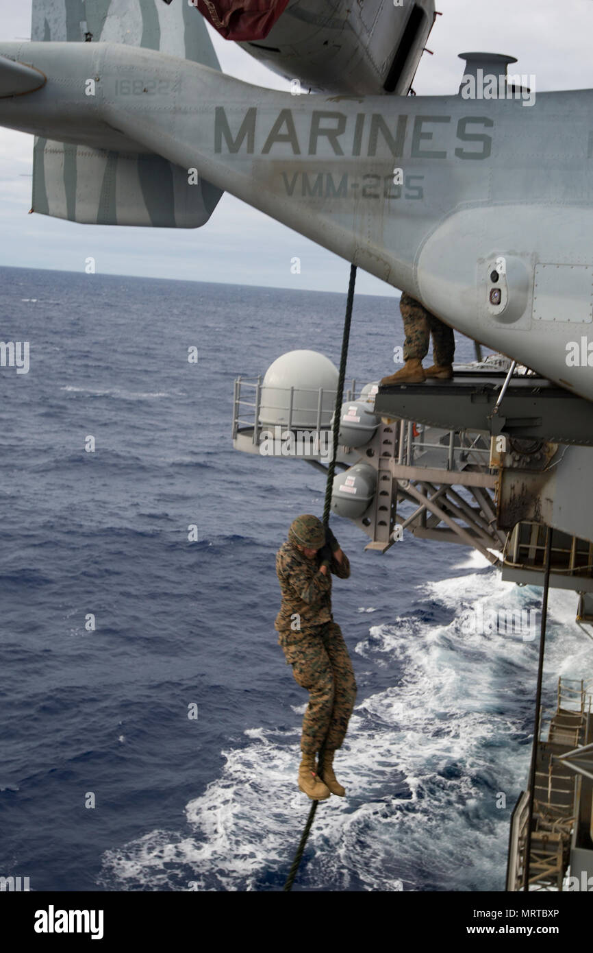 A Marine with the 31st Marine Expeditionary Unit rappels from the exit ...